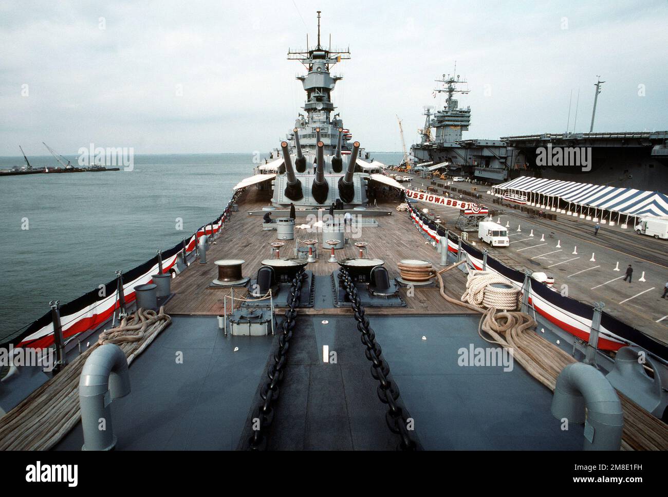 Sailors work aboard the battleship USS IOWA (BB-61) following the ship ...