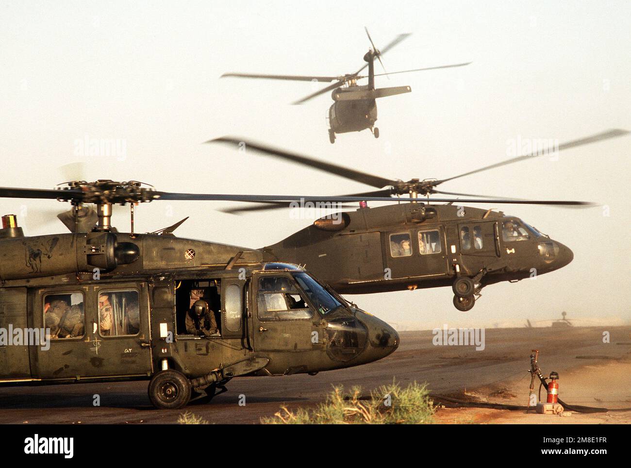 U.S. Army UH-60 Black Hawk (Blackhawk) helicopters lift off from a ...