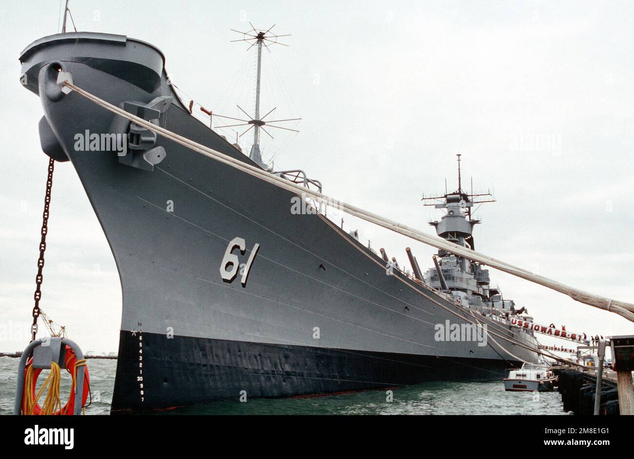 A port bow view of the battleship USS IOWA (BB 61) as it lies tied up at the pier for its ...