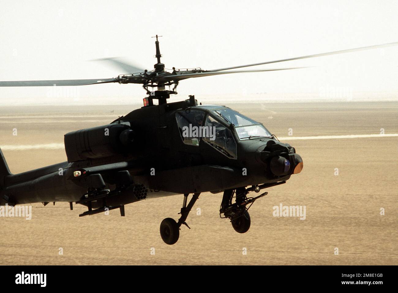 A left front view of a U.S. Army AH-64 Apache helicopter in flight ...