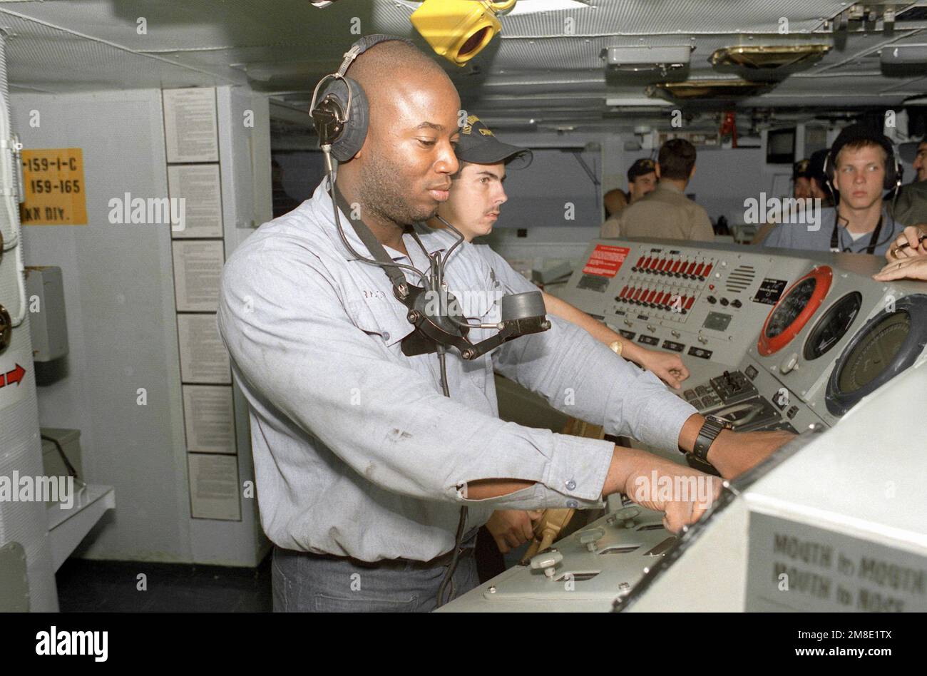 Boatswain's Mate 3rd Class James Reed works at the lee helmsman's ...