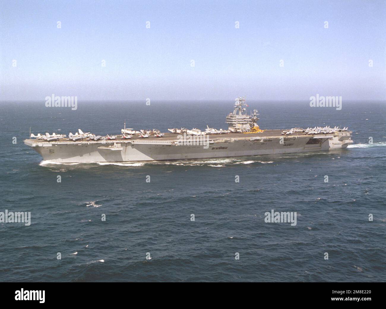 A port beam view of the nuclear-powered aircraft carrier ABRAHAM ...
