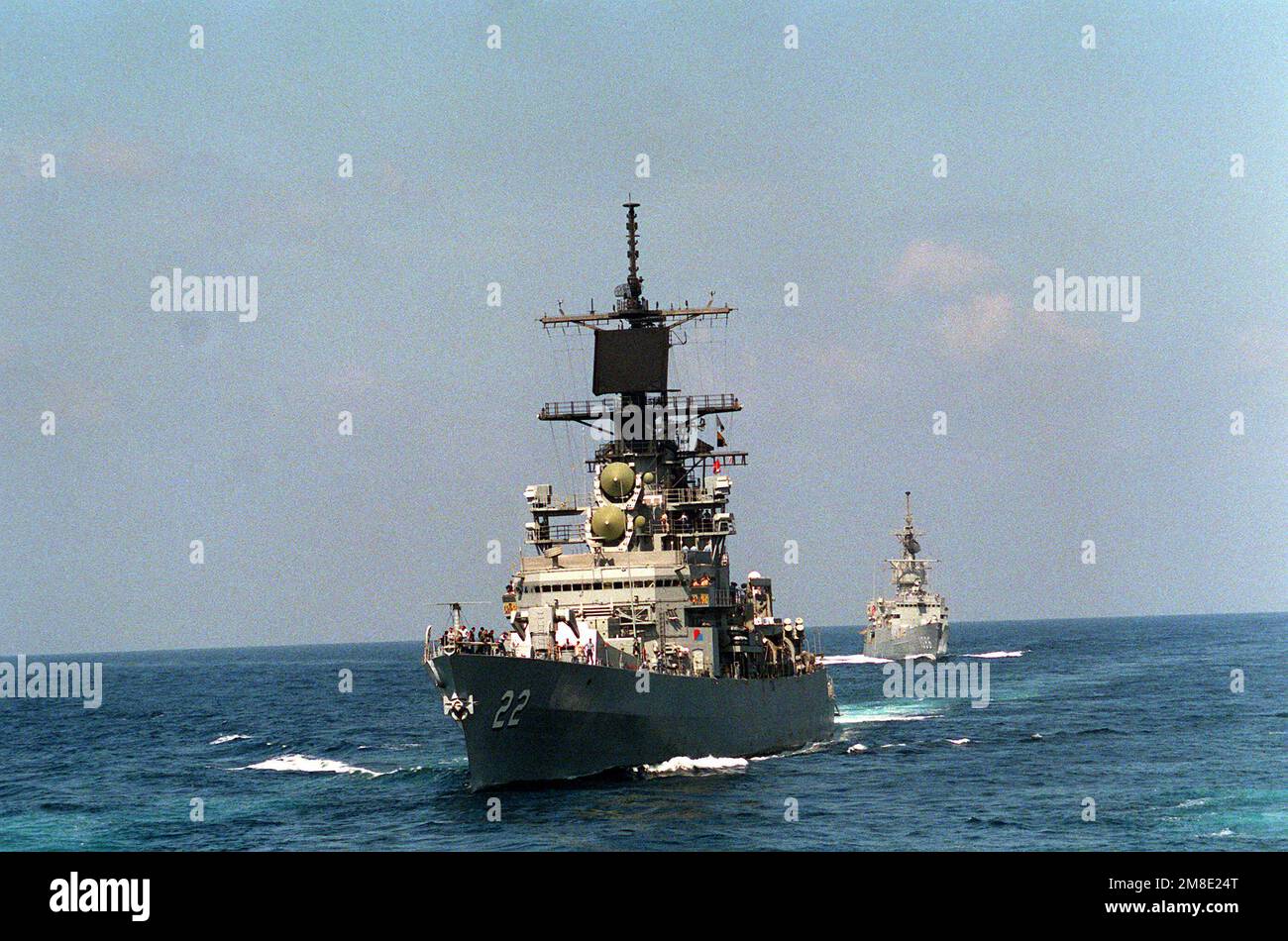 The frigate USS BREWTON (FF-1086) follows the guided missile cruiser ...