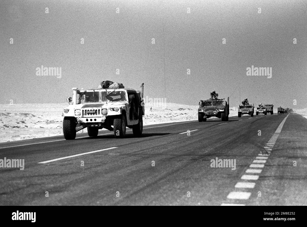 A convoy of M998High-Mobility Multipurpose Wheeled Vehicles (HMMWV) and ...