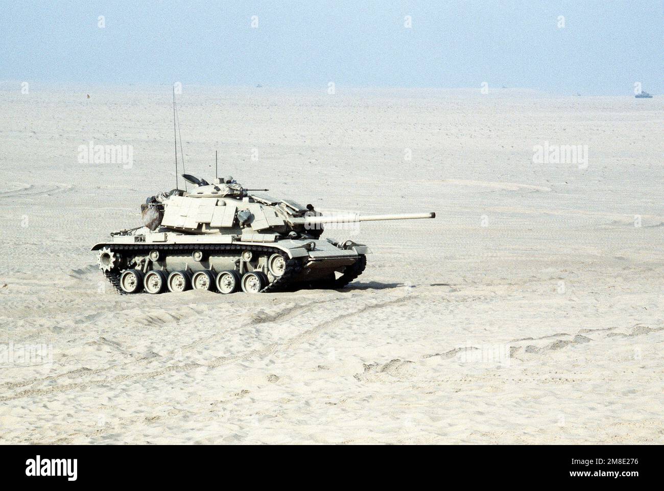 A Marine from the 3rd Tank Battalion sits on the hull of an M-60A1 main ...