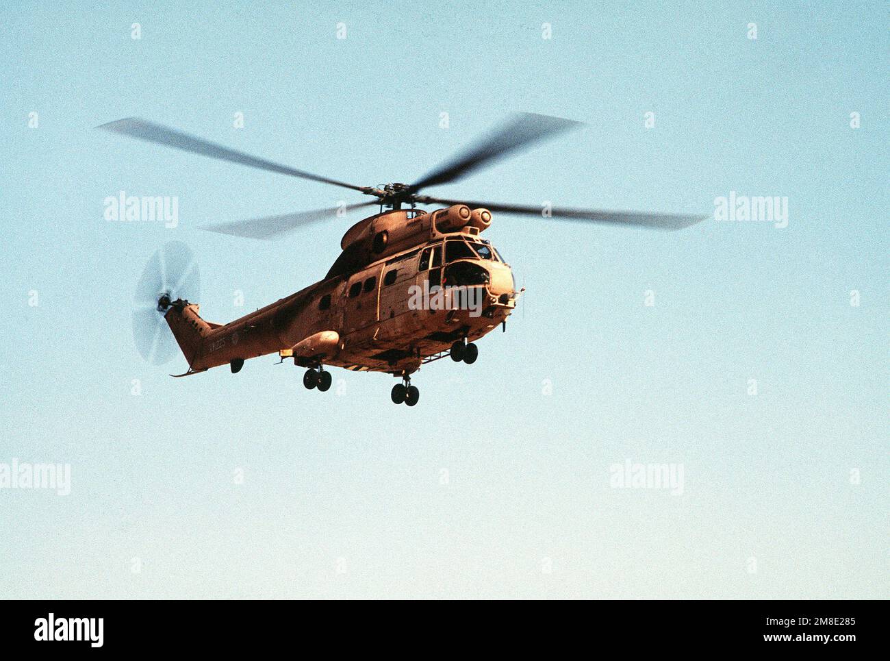 A British HC. Mark 1 Puma helicopter flies over the city's airfield ...