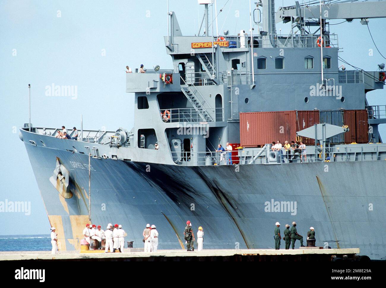 Line handlers stand by as the Military Sealift Command auxiliary crane ...