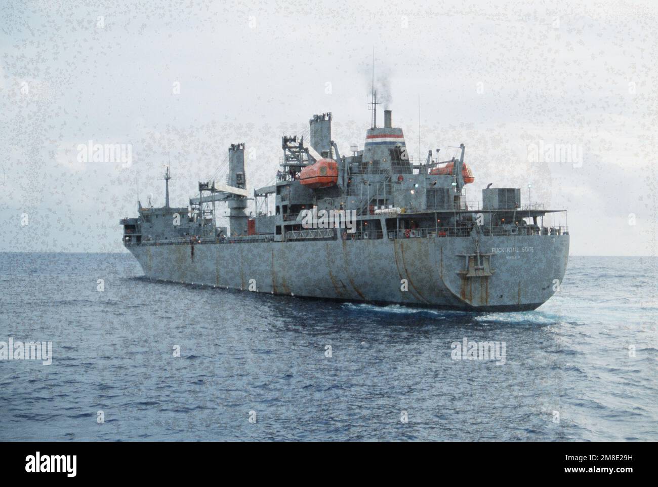 A port quarter view of the Military Sealift Command auxiliary crane ...