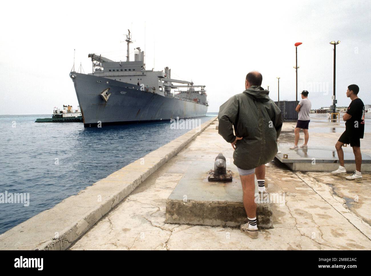 Line handlers stand by as the Military Sealift Command auxiliary crane ...