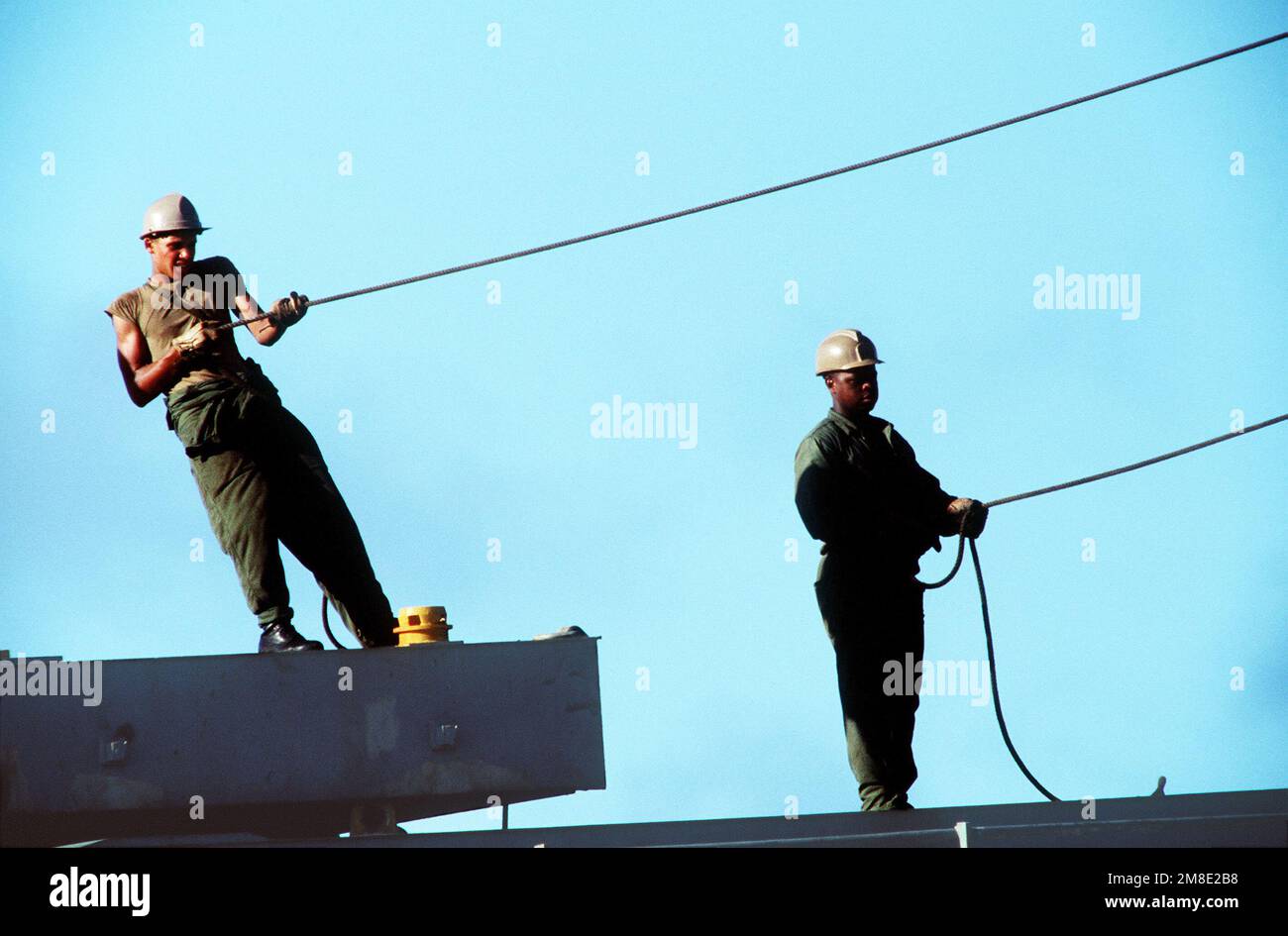 Two soldiers from the 155th Transportation Company hold onto guide ...