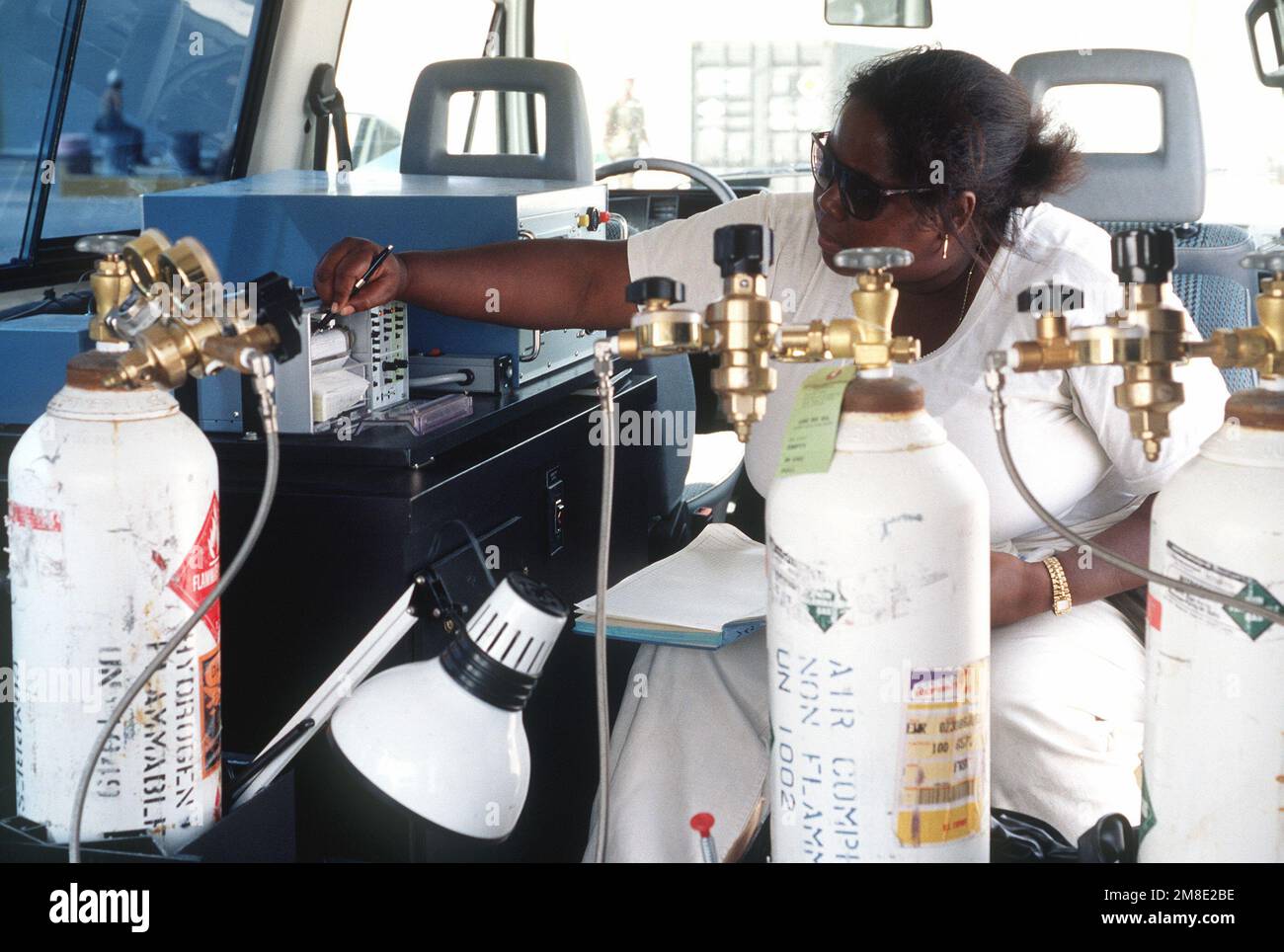 Martha Bryant, a civilian contractor, makes a notation on the printout ...