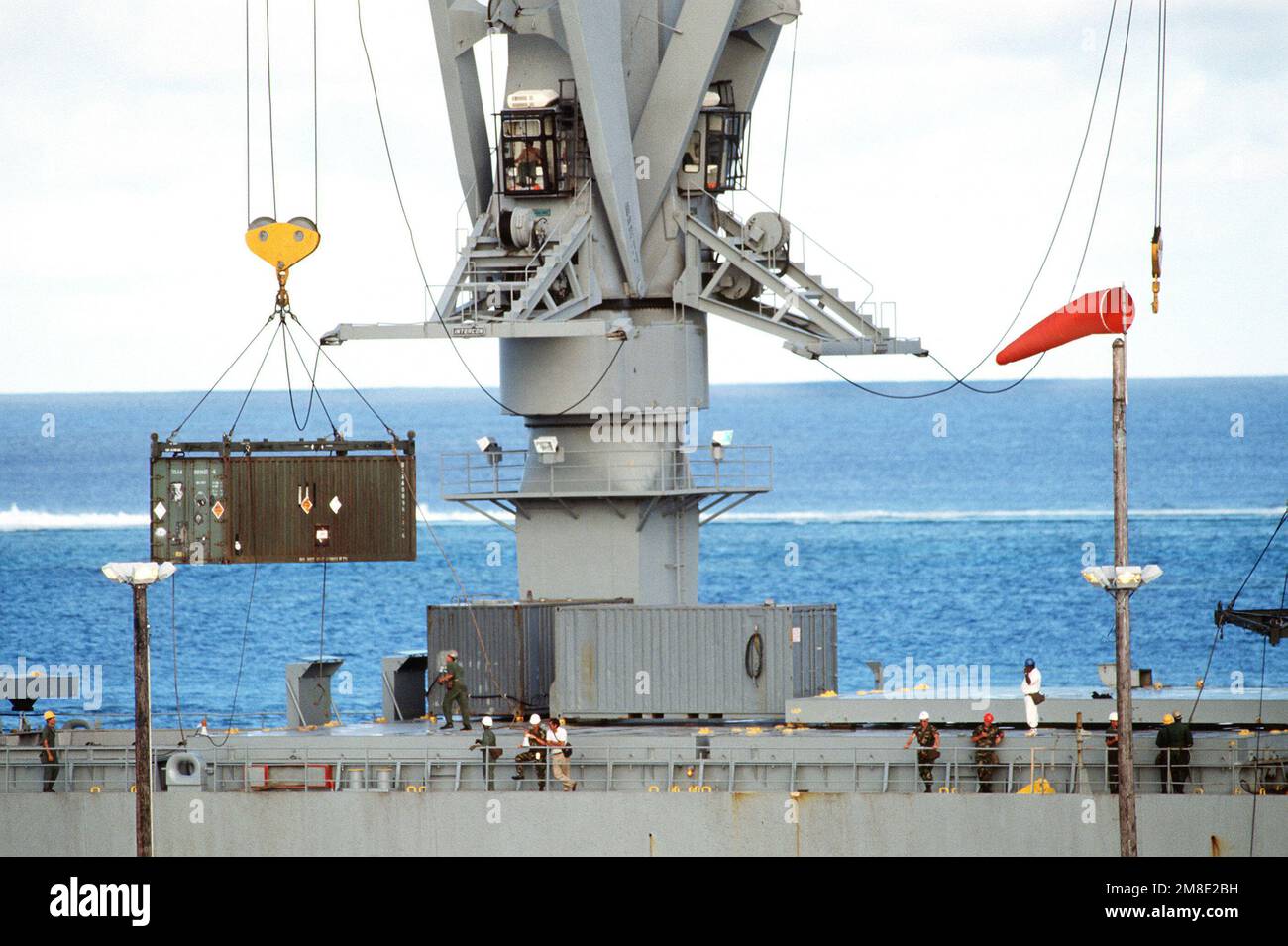 A container of chemical munitions is hoisted from the deck of the ...
