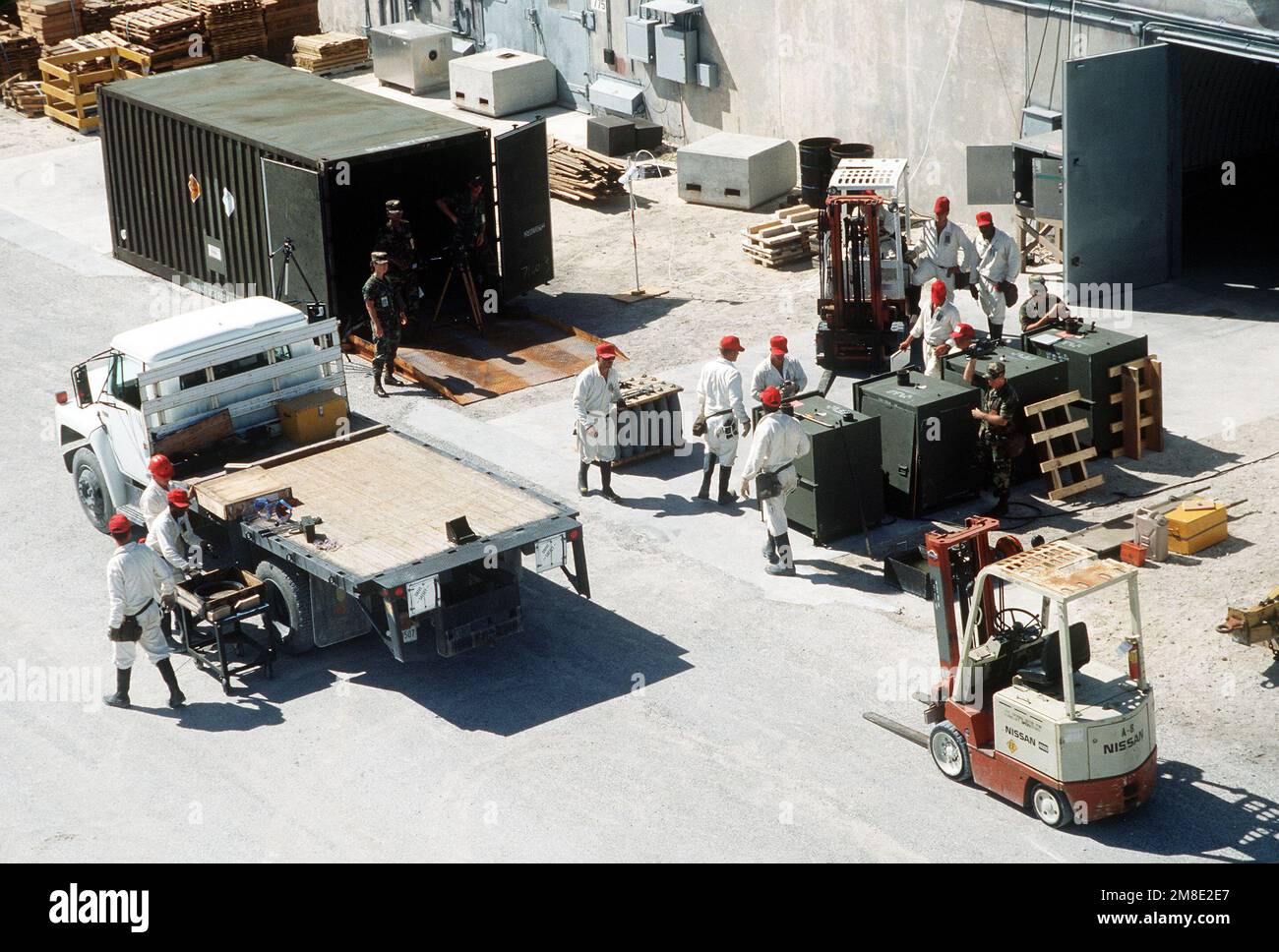 Soldiers unload crates of chemical munitions before placing the ...