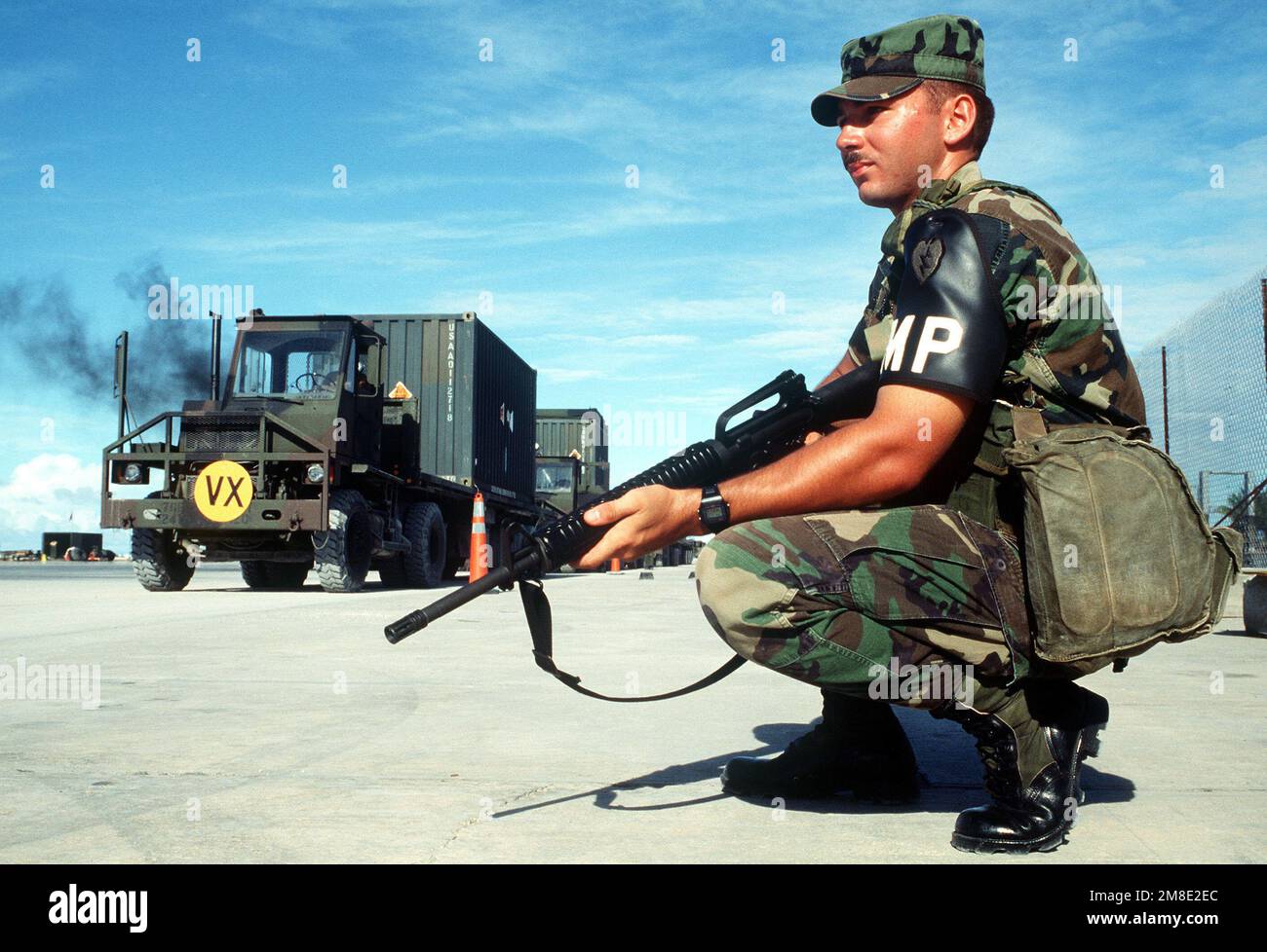 A soldier from the 58th Military Police Company stands guard with an M ...