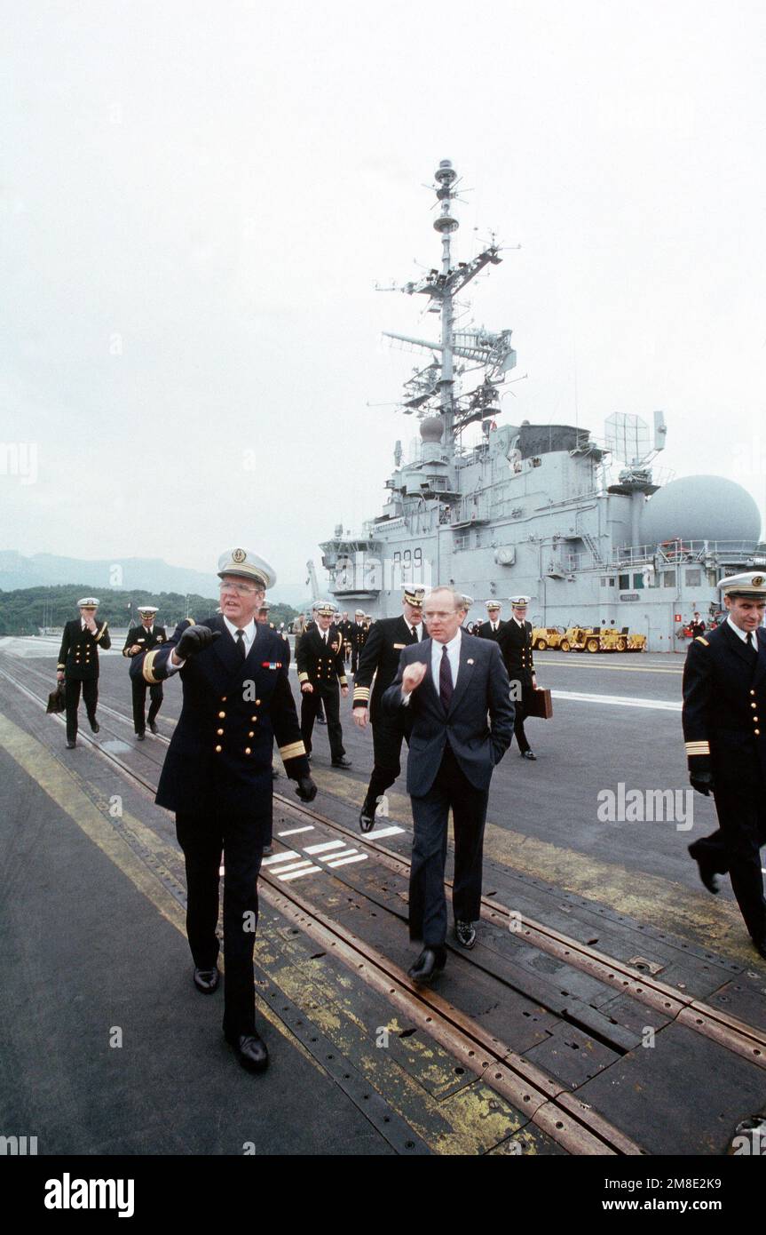 Secretary of the Navy H. Lawrence Garrett III walks across the flight ...
