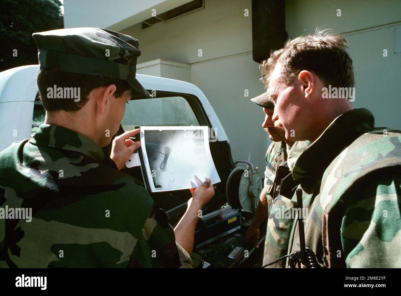 Members of an explosive ordnance disposal (EOD) team check over an X ...