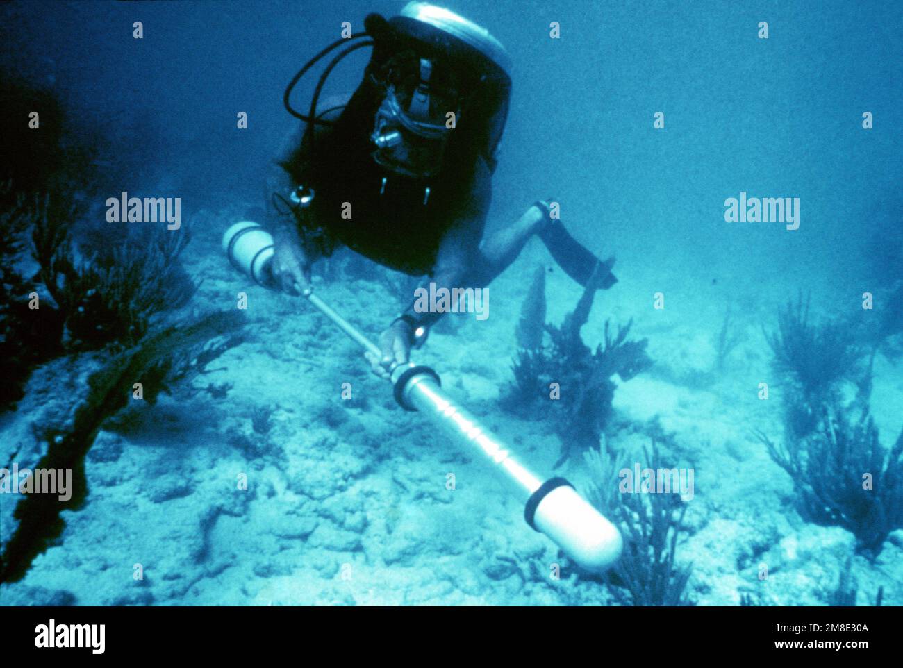 An explosive ordnance disposal (EOD) diver uses a Mark 10 ordnance ...