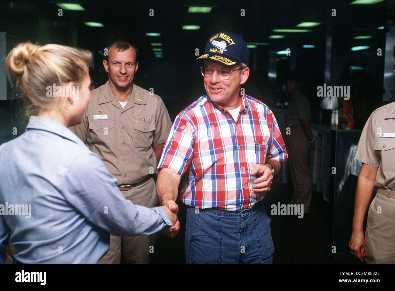 Secretary of the Navy H. Lawrence Garrett III shakes hands with crew ...