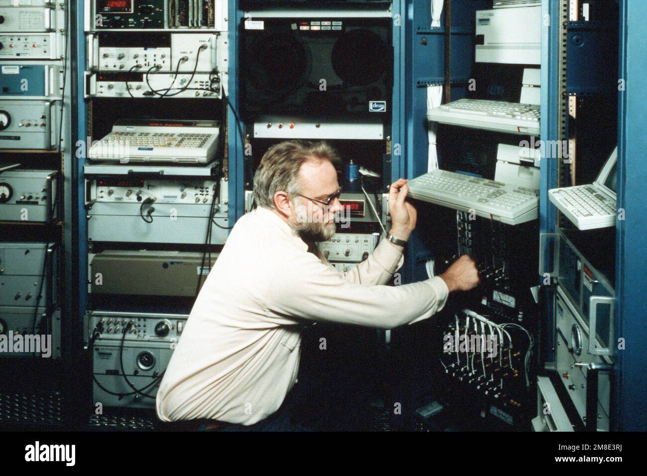 Al Gifford checks a cable on the phase time measurement system in the ...