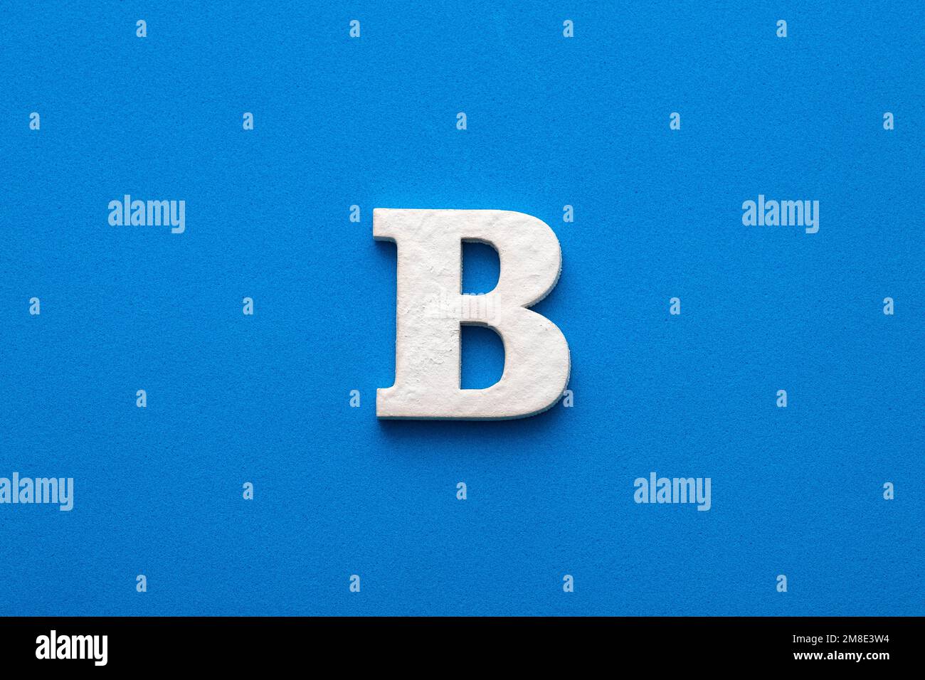Alphabet letter B - White wooden letter on blue foamy background Stock ...