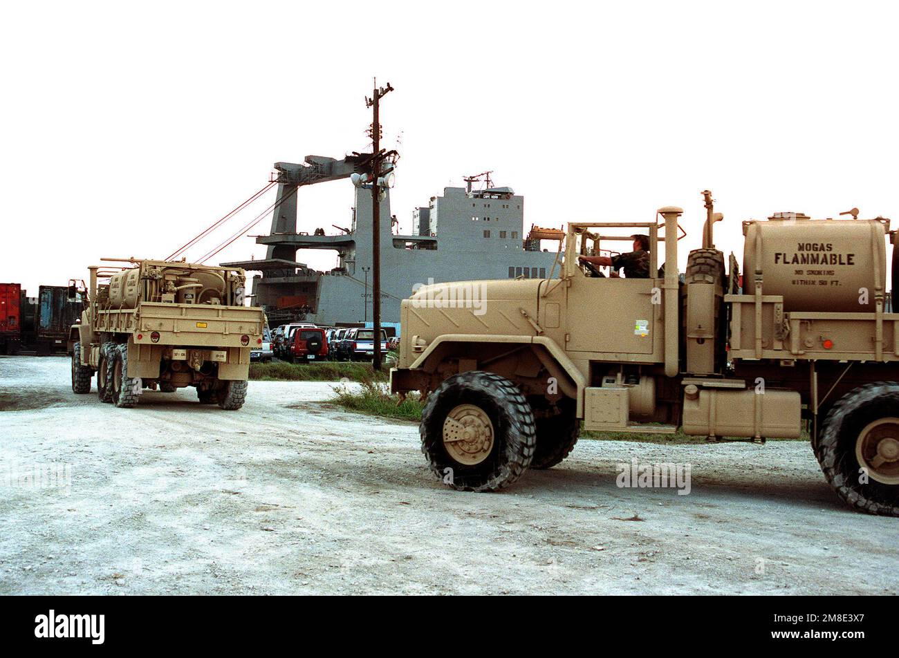 M-939 5-ton fuel trucks move toward the loading ramp of the Ready ...