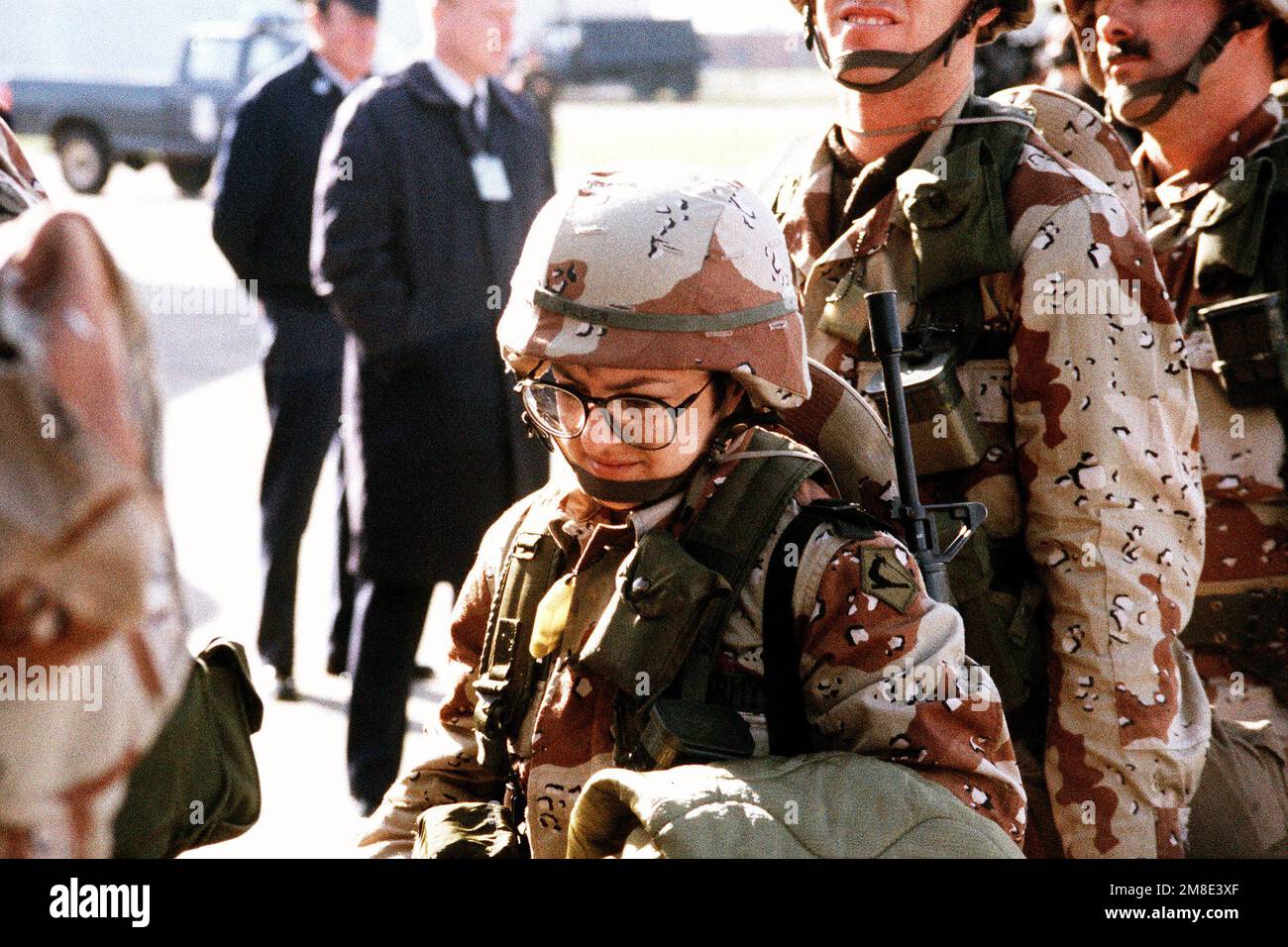 An Army reservist stands in line with other members of her unit as they ...