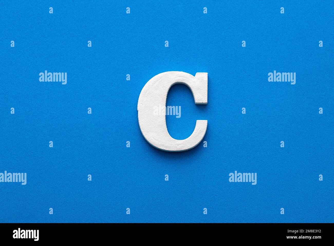 Letter C uppercase - White wood font on blue foamy background Stock ...