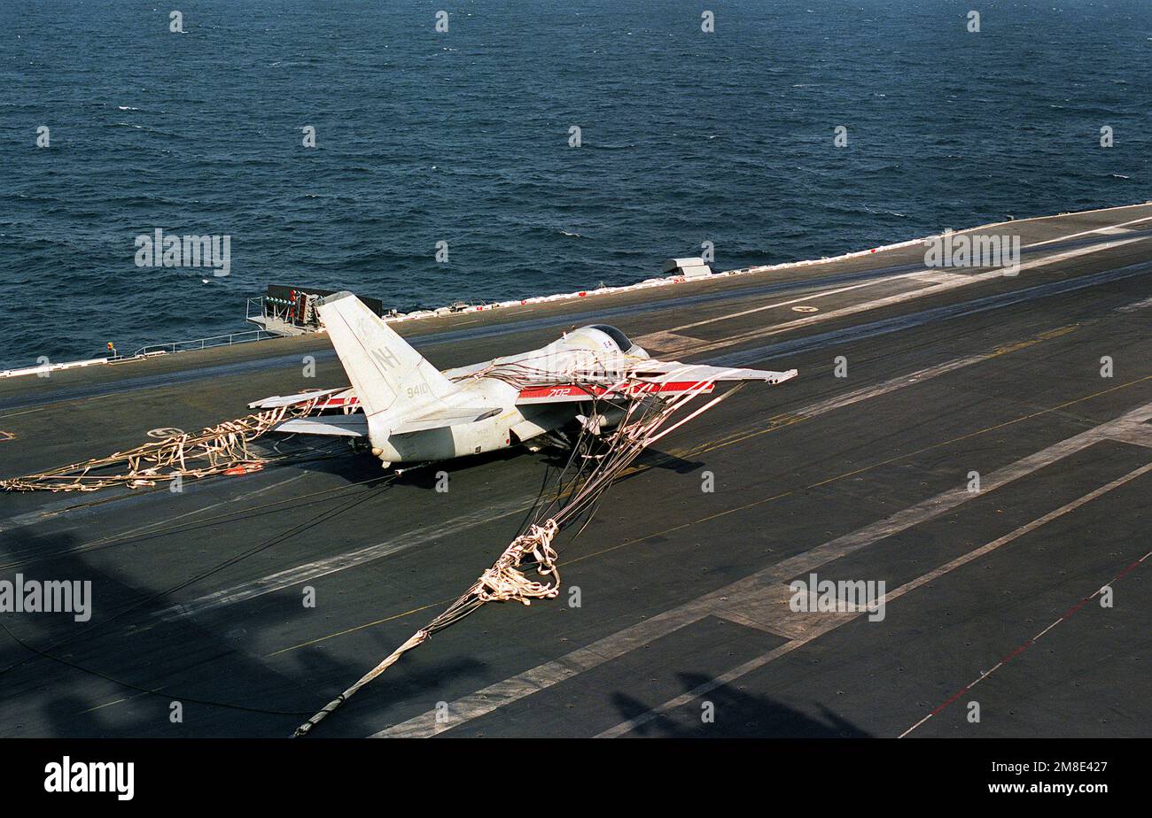 Wrapped in the crash barricade and trailing an arresting wire, an Air ...