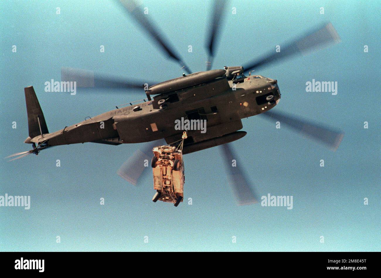 A Marine Corps CH-53E Super Stallion helicopter lifts an M998 High ...
