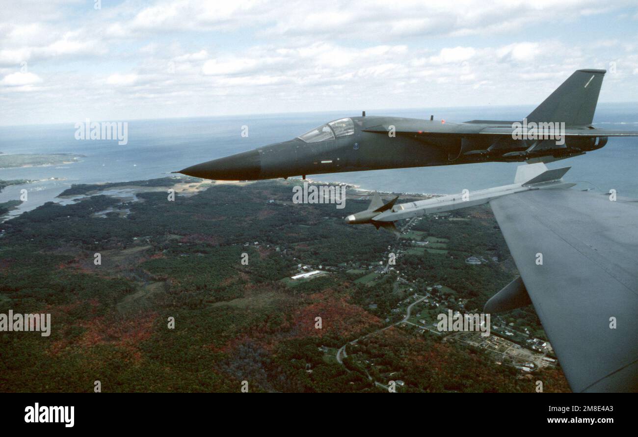 An AIM-9 Sidewinder missile is positioned on the wing of an F-16 ...