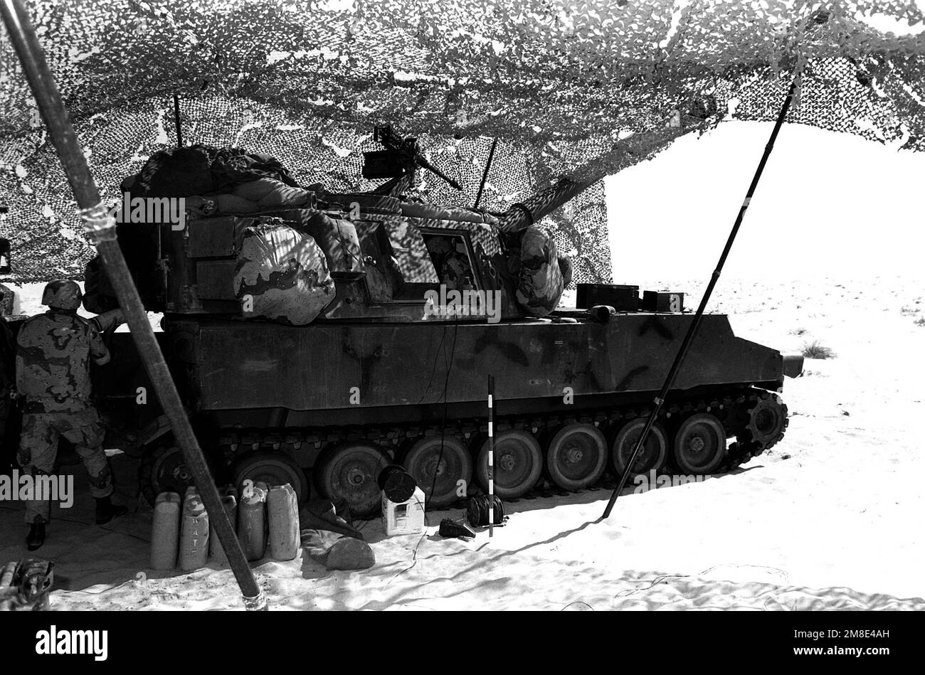 A crewman passes a 155mm projectile into an R Battery, 5th Battalion ...