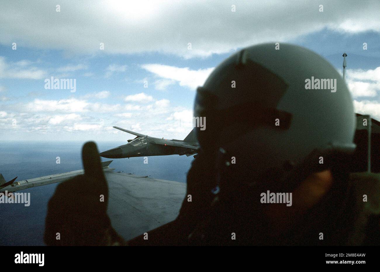 A pilot signals to the pilot of a 509th Bombardment Wing FB-111A ...