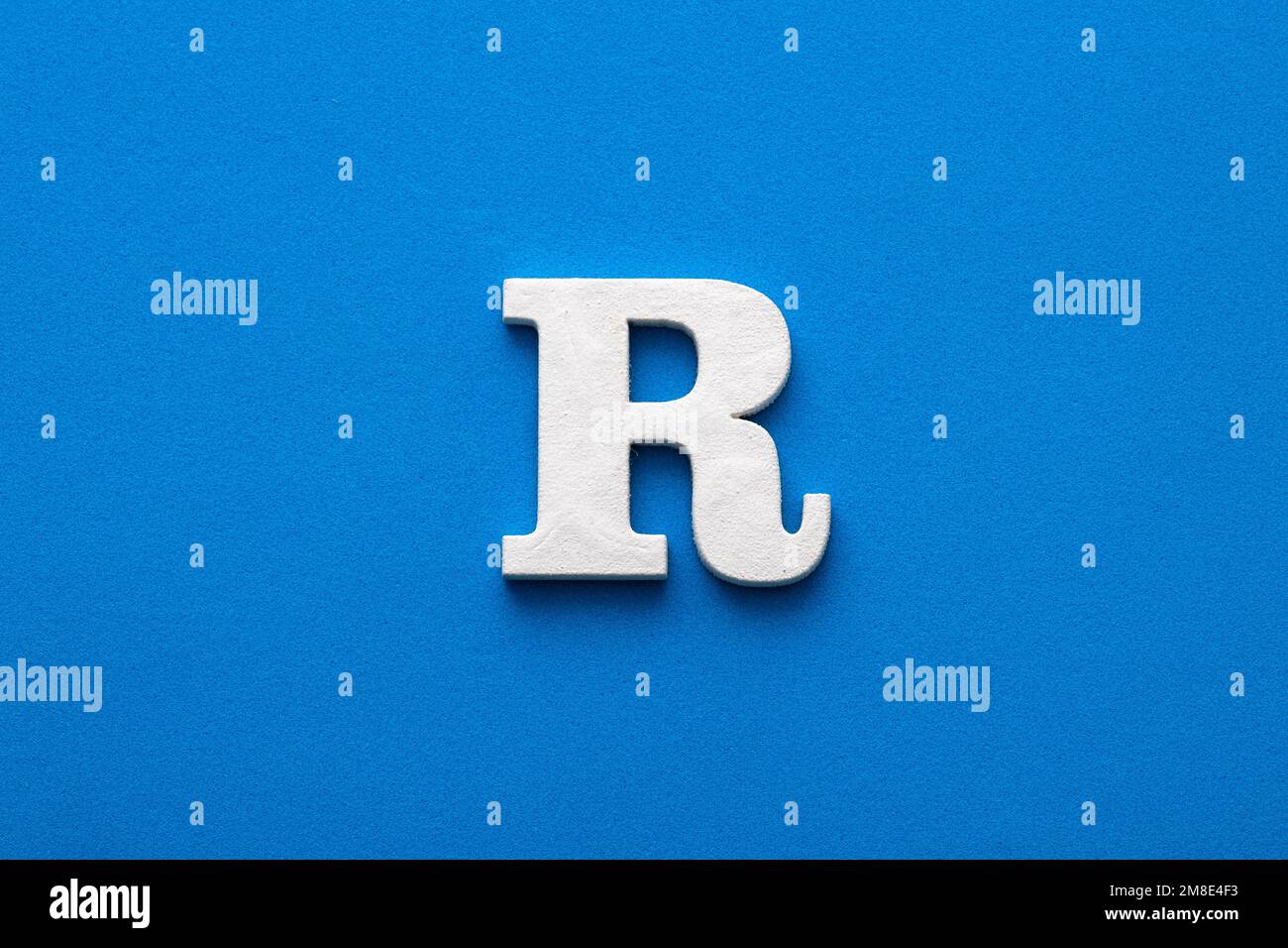 Alphabet letter R - White wooden letter on blue foamy background Stock ...