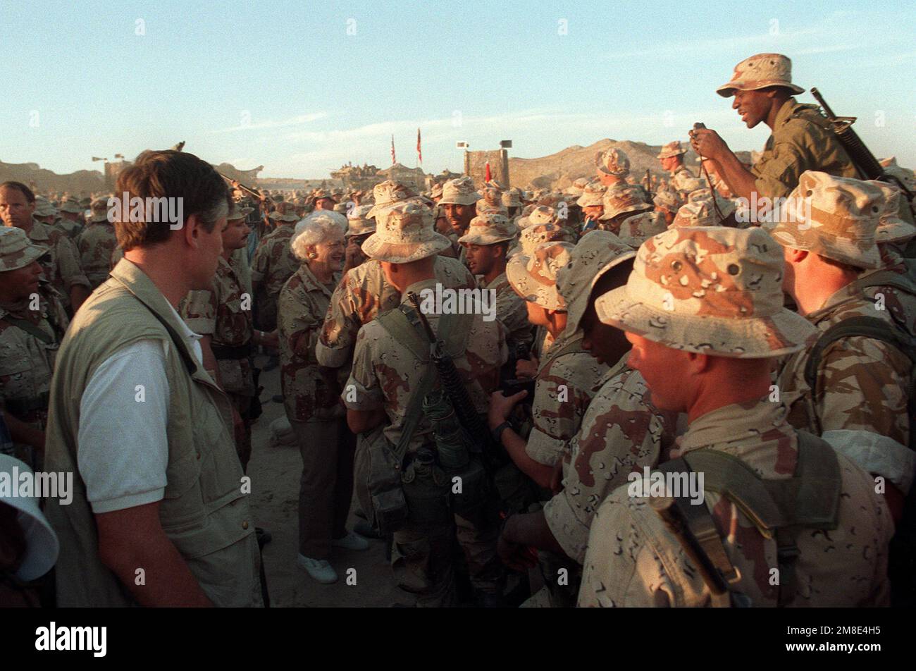 First Lady Barbara Bush talks with a Marine as she works her way ...