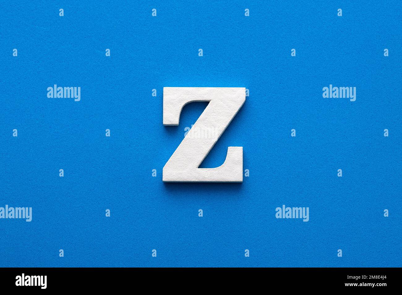 Alphabet letter Z - White wooden letter on blue foamy background Stock ...