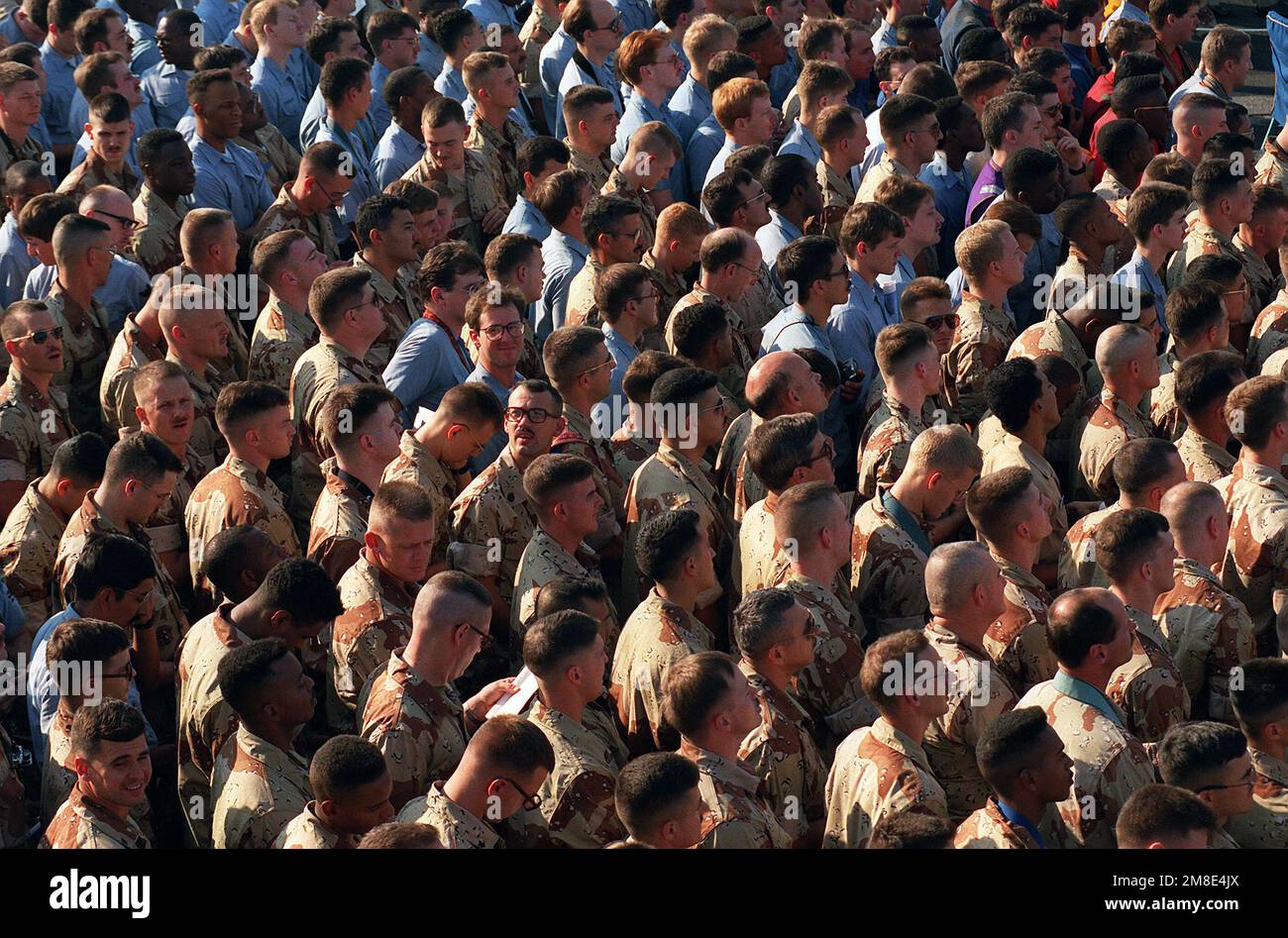 Marines and sailors crowd the flight deck of the amphibious assault ...