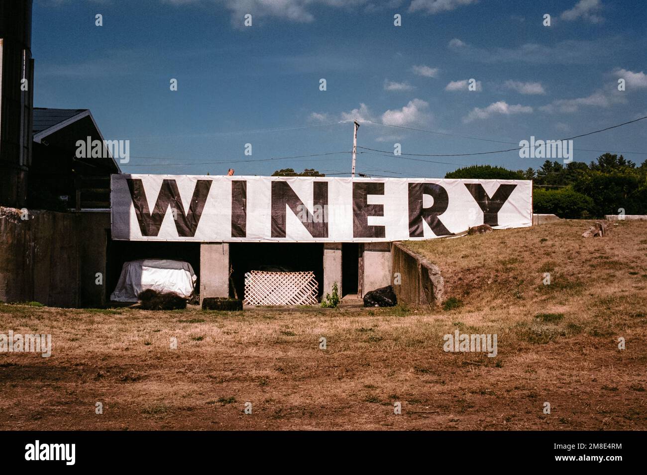 A large white banner reads Winery above a garage at the Alfalfa Farms ...