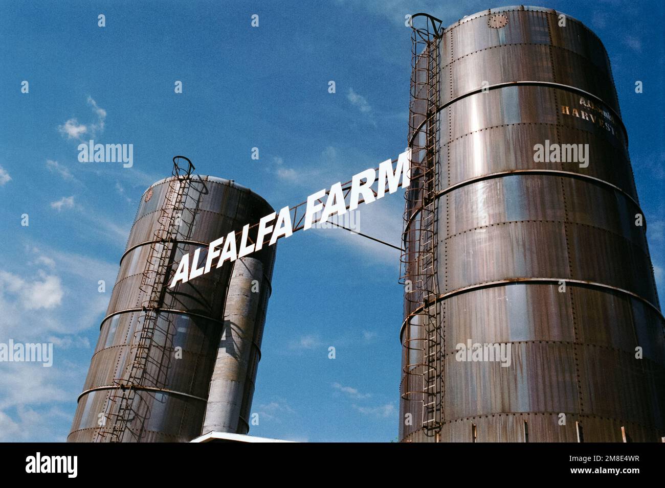 Twin silos with a sign reading Alfalfa Farms hanging between them at ...