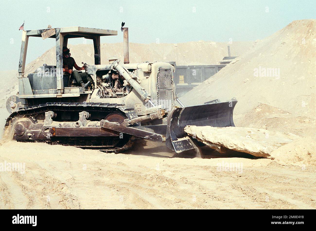 A Seabee from Naval Mobile Construction Battalion 40 (NMCB-40) uses a ...