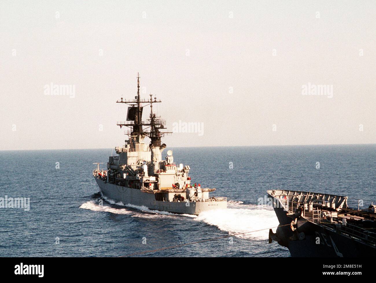 The guided missile cruiser USS BIDDLE (CG-34) passes the fast combat ...