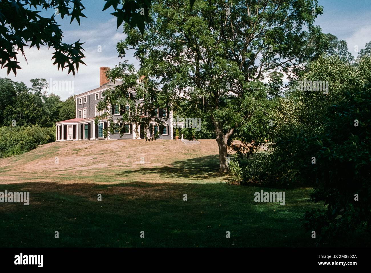 The main house on the hill behind trees at the Codman Estate. Lincoln ...