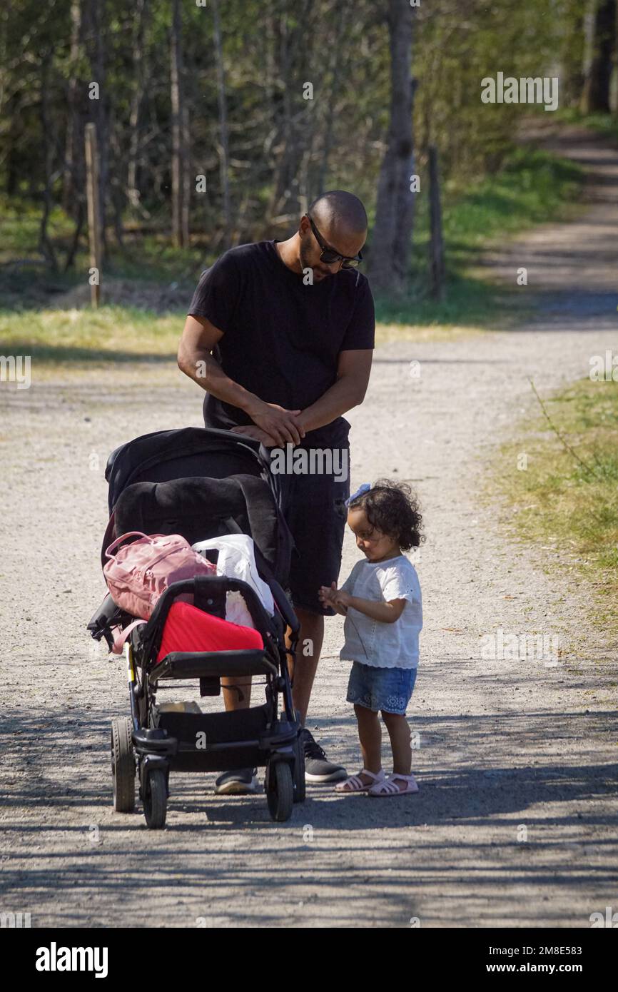 Father with stroller standing with child on a road Stock Photo - Alamy