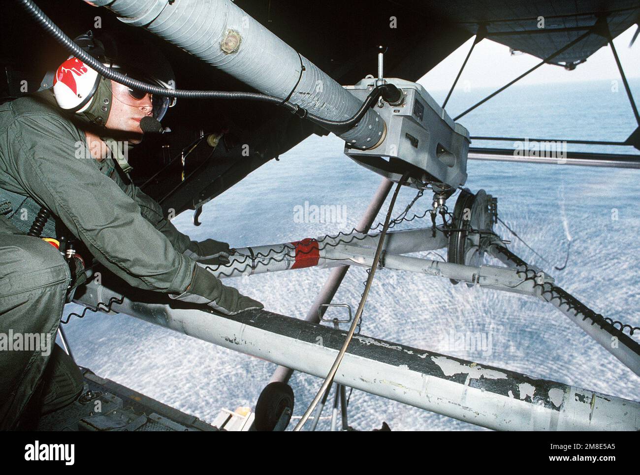 Aviation Technician 3rd Class Tom Schmitt checks the rigging of the AQS ...