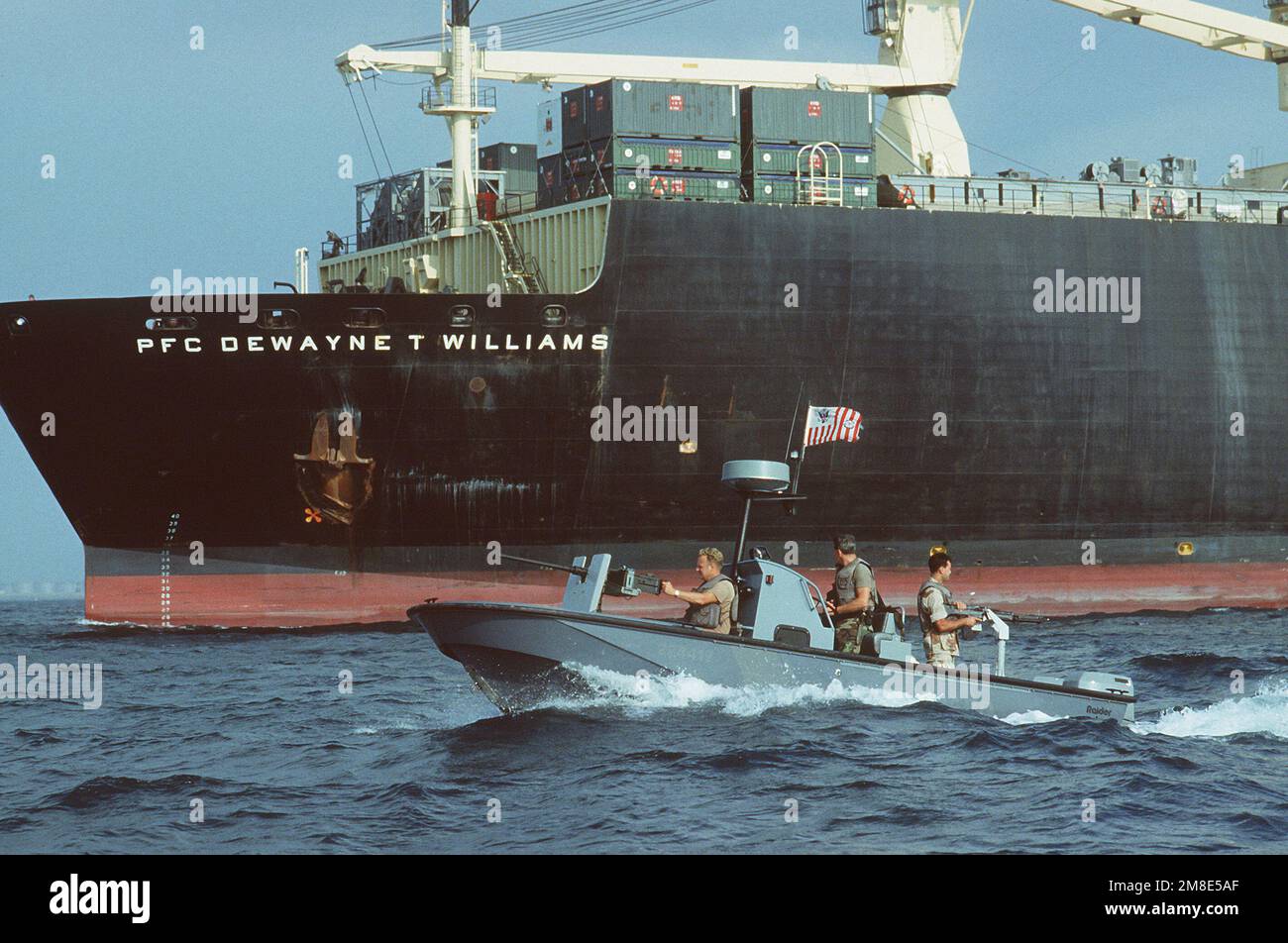 Members of a U.S. Coast Guard security unit patrol the harbor near the ...