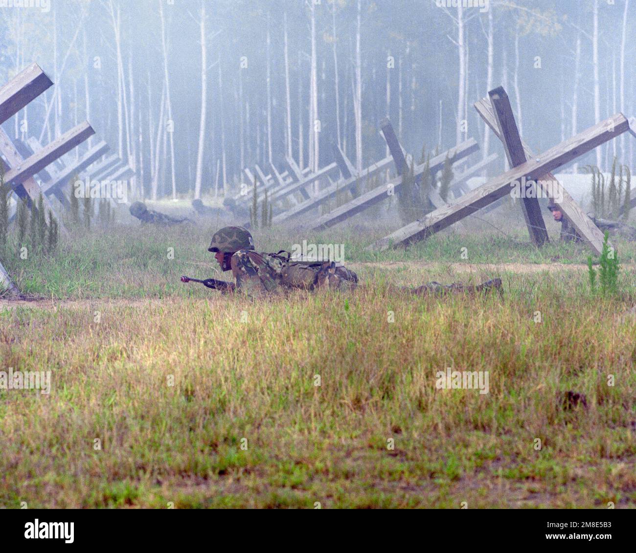 A 1ST Battalion recruit crawls on an infiltration course. Base: Usmc ...