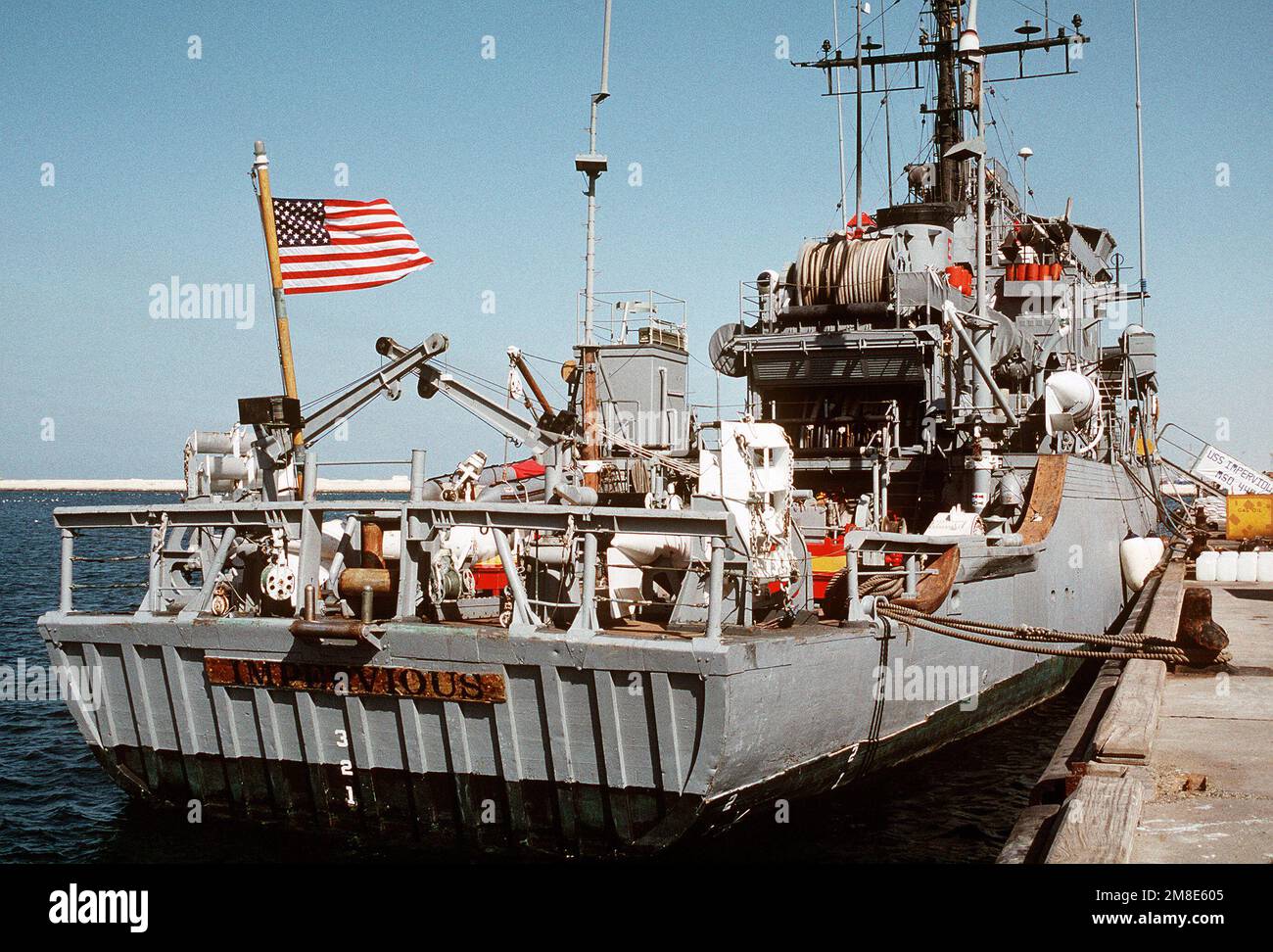 The ocean minesweeper USS IMPERVIOUS (MSO-449) lies tied up in port ...