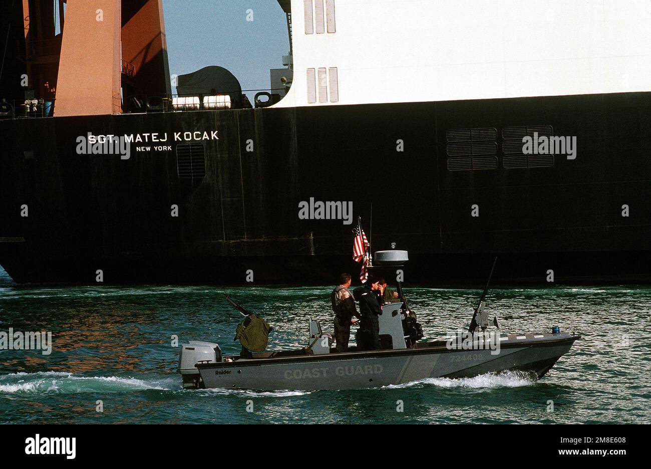 Coast Guard personnel in a Sea Raider utility craft patrol the waters ...