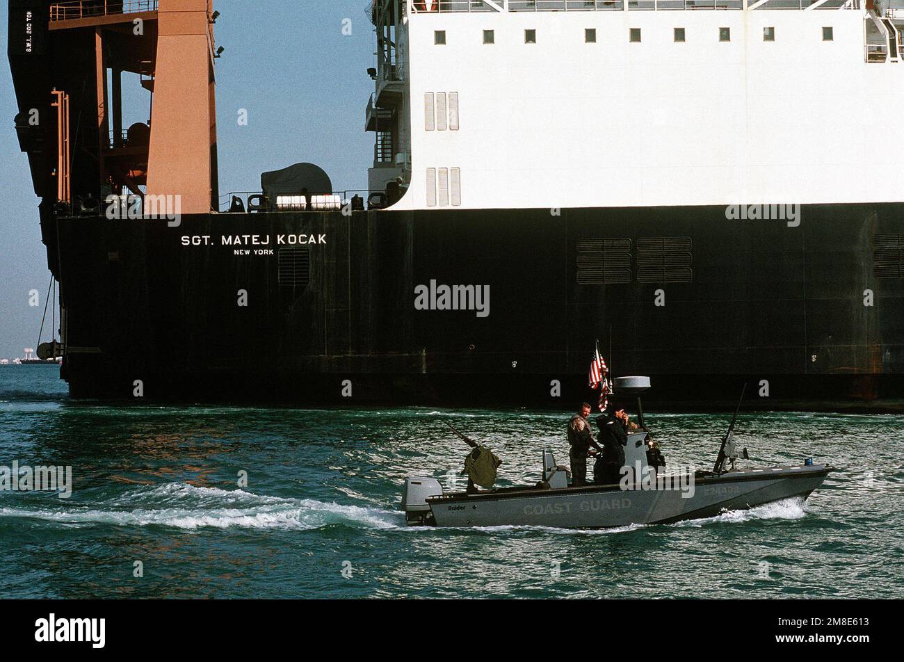 Coast Guard personnel in a Sea Raider utility craft patrol the waters ...