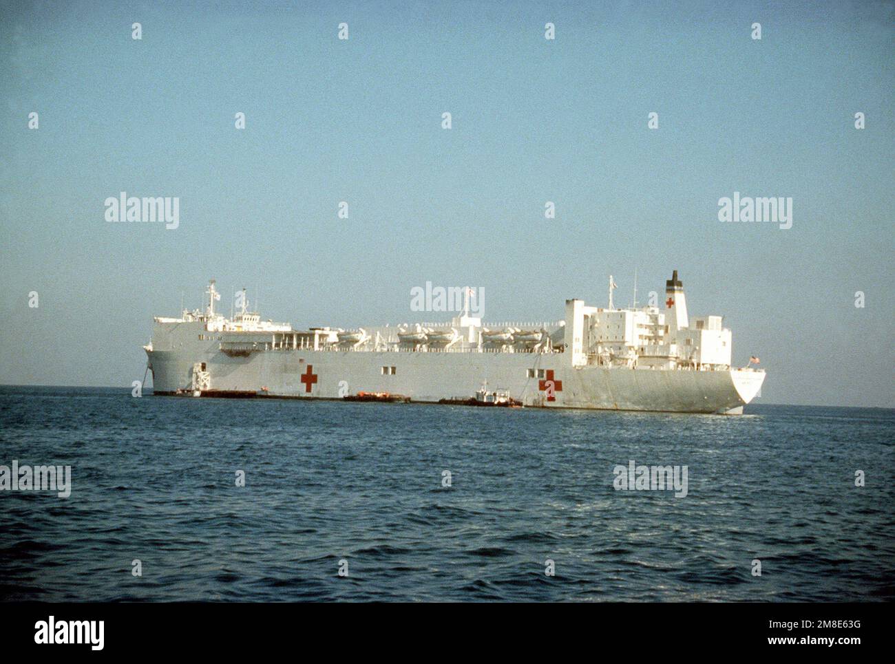 The hospital ship USNS MERCY (T-AH-19) lies at anchor while deployed to ...