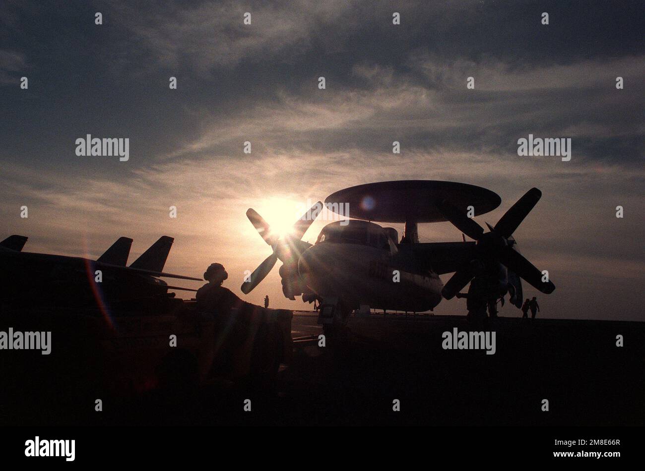 Aircraft handlers use an MD-3A tow tractor to respot a Carrier Airborne ...